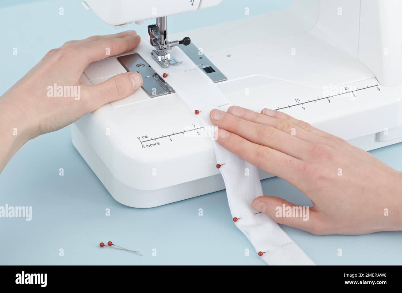 Making a headband, stitching the length of fabric tube Stock Photo - Alamy