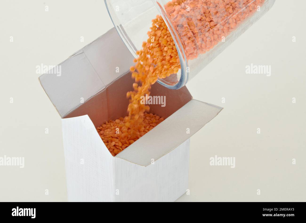 Making house doorstop, add lentils to box Stock Photo - Alamy