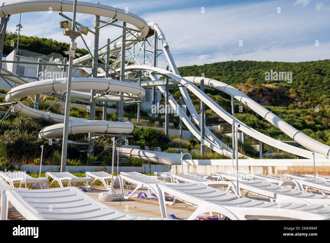Empty indoor mountain summer water park with high extreme winding white ...