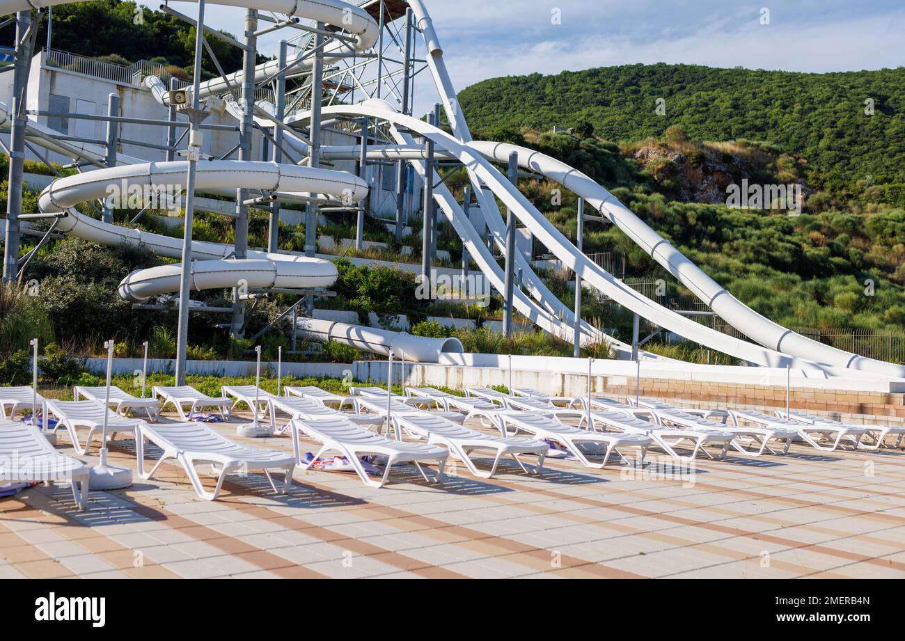 Empty indoor mountain summer water park with high extreme winding white ...