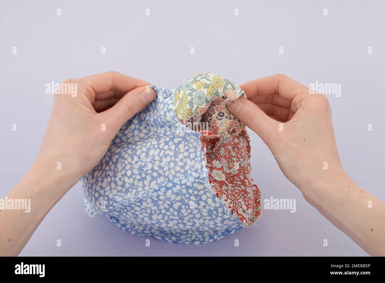 Pull tenticles of toy octopus through stuffing hole Stock Photo - Alamy
