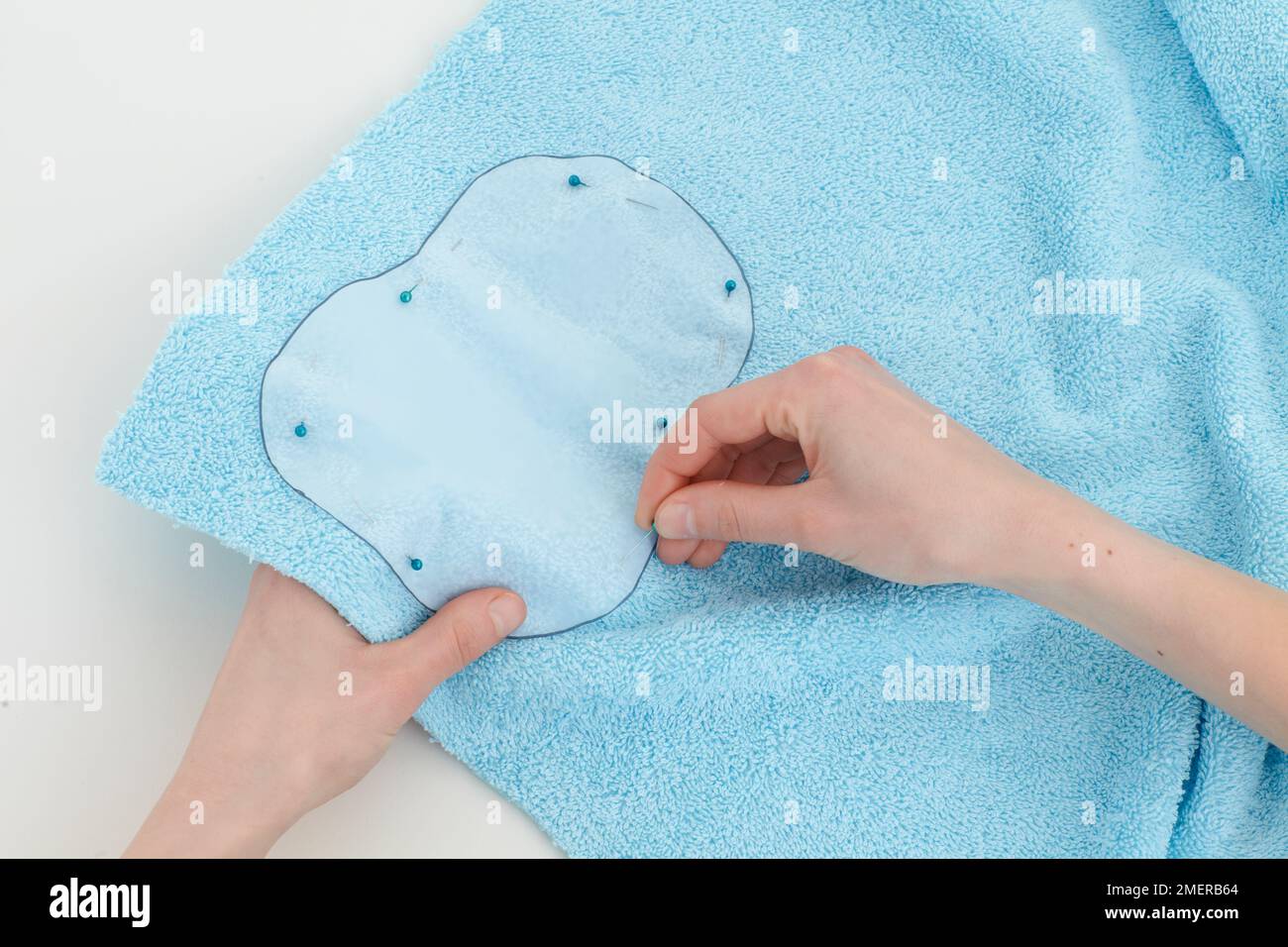 Pin pattern to fabric for bathtime wrap Stock Photo - Alamy