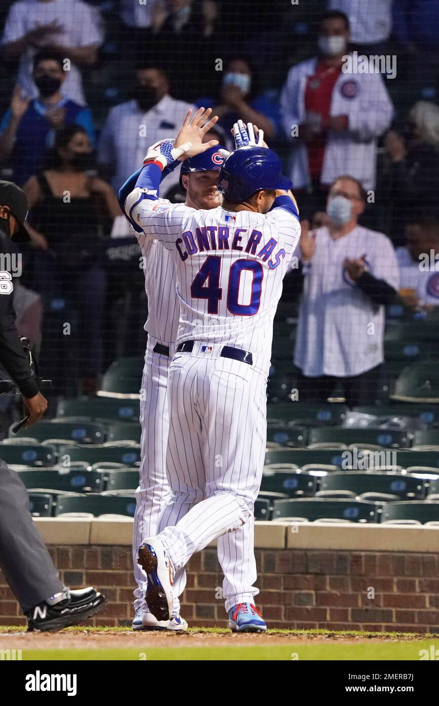 Chicago Cubs' Willson Contreras (40) is greeted by Ian Happ (8) after ...