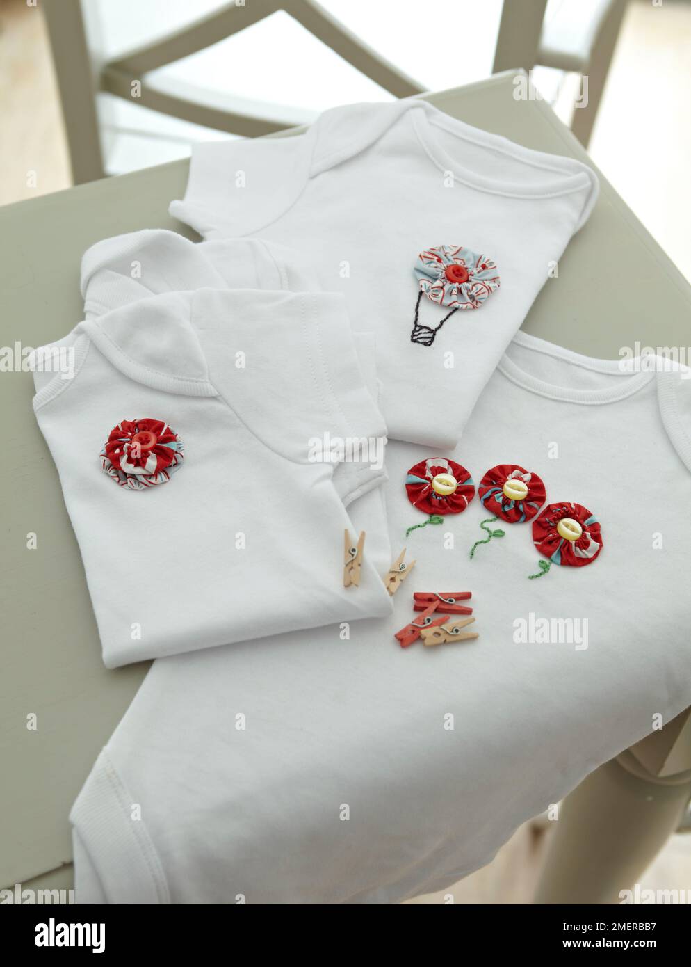 Rosette embellished baby onesies Stock Photo - Alamy