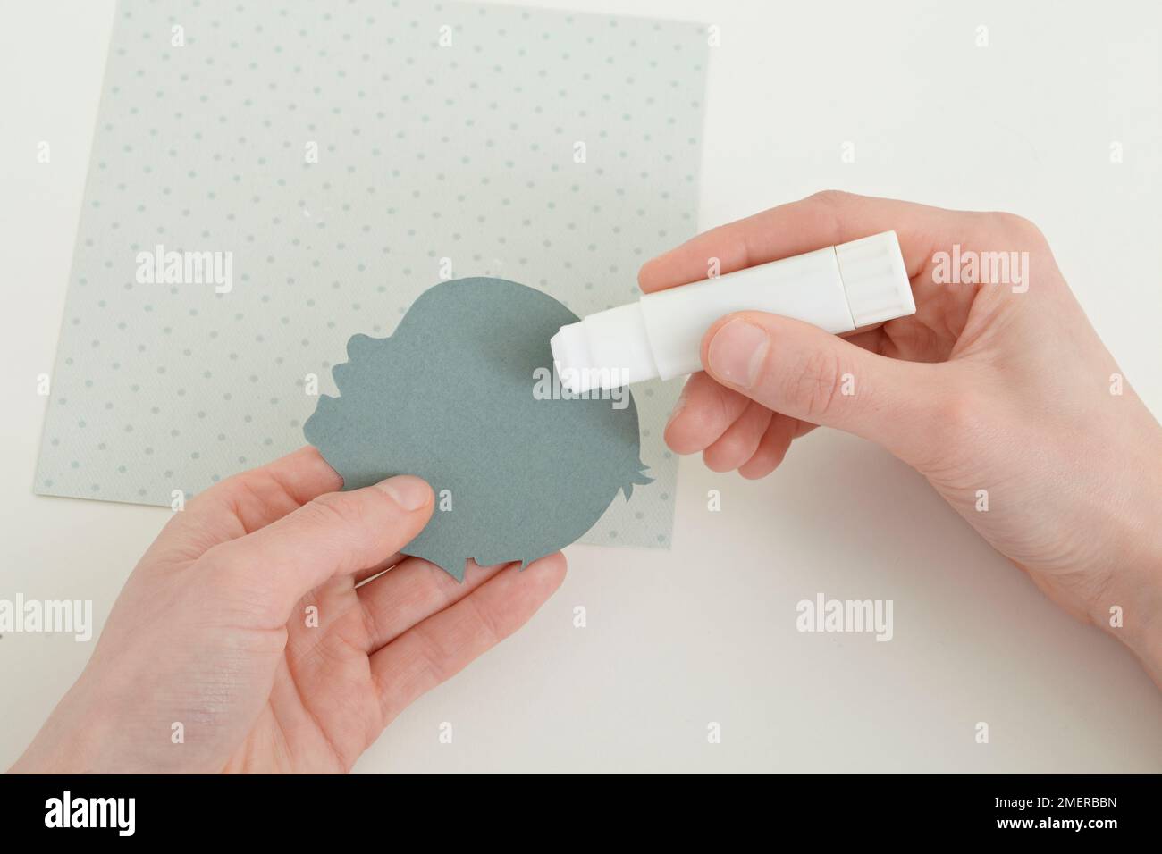 Sticking silhouette of baby's head with glue Stock Photo - Alamy