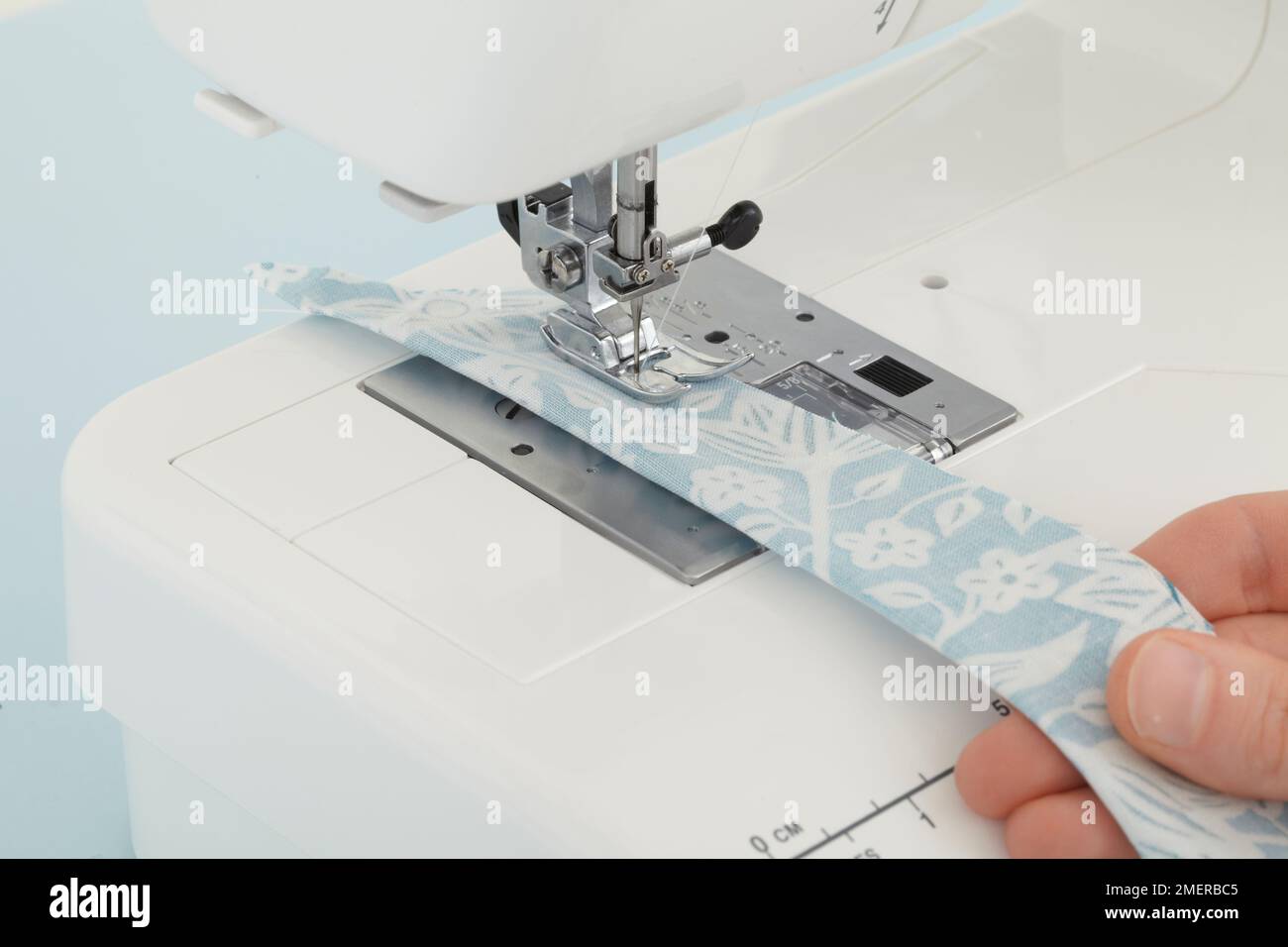 Making a bonnet, fold, pin and sew tie band peices Stock Photo - Alamy