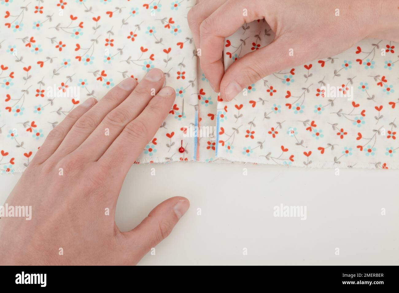 Making a box pleat, folding fabric to line up Stock Photo - Alamy