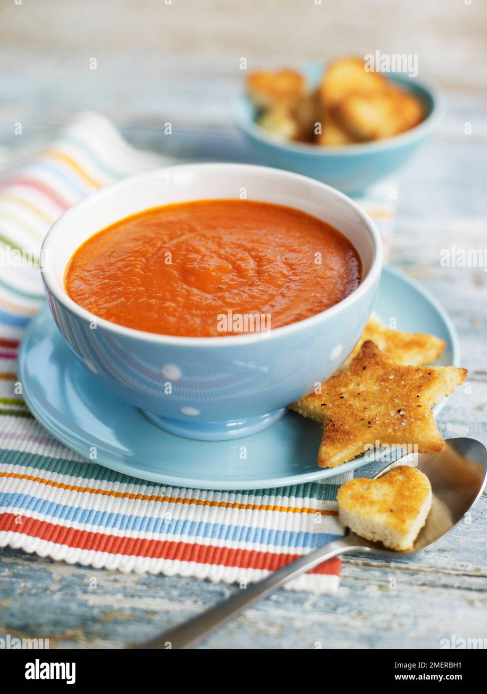 Tomato soup served in bowl with star-shaped and heart-shaped toasted ...