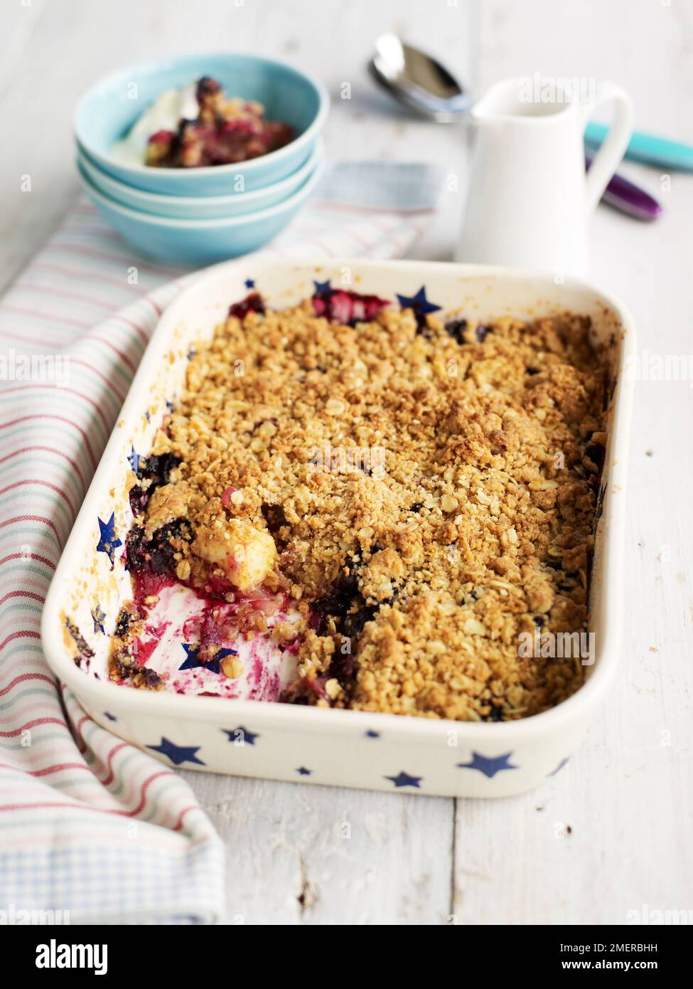 Apple and grape crumble bake in pie dish Stock Photo - Alamy