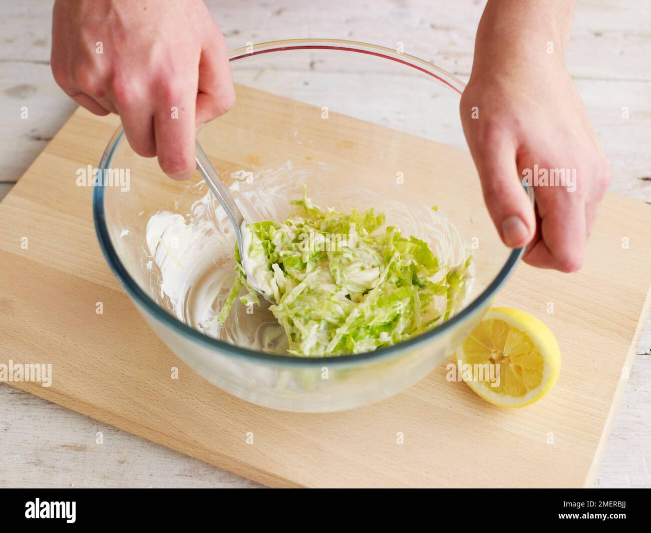 Club sandwich, mixing mayonnaise and lettuce in large bowl Stock Photo ...