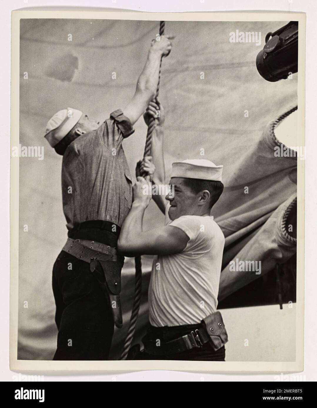 Coast Guardsmen Operate a Sail. This image depicts two Coast Guardsmen ...