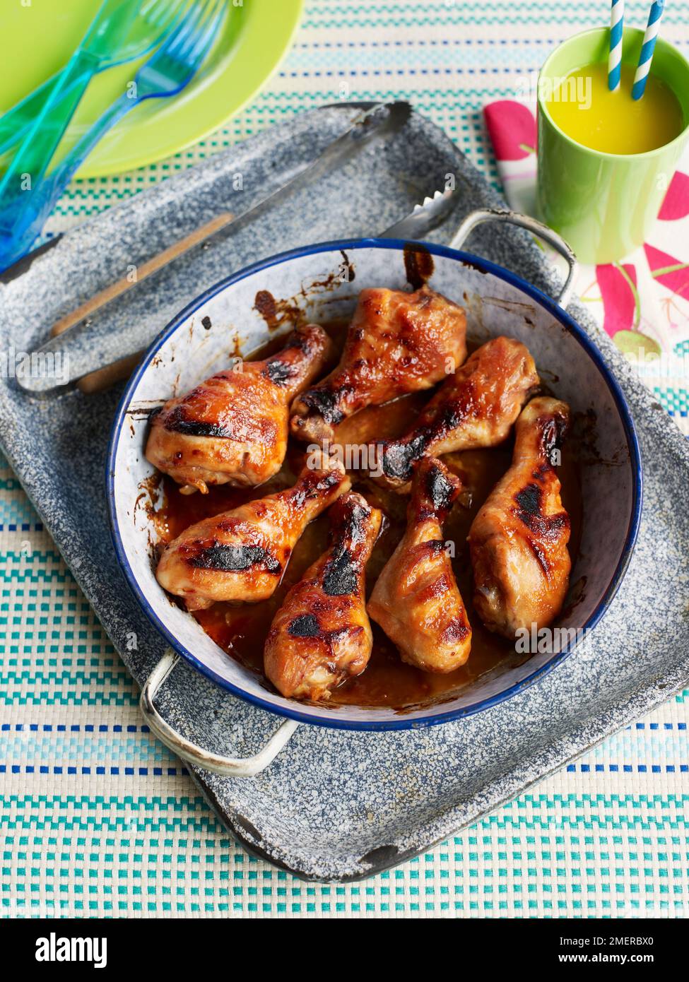BBQ chicken thighs in large round baking dish Stock Photo - Alamy