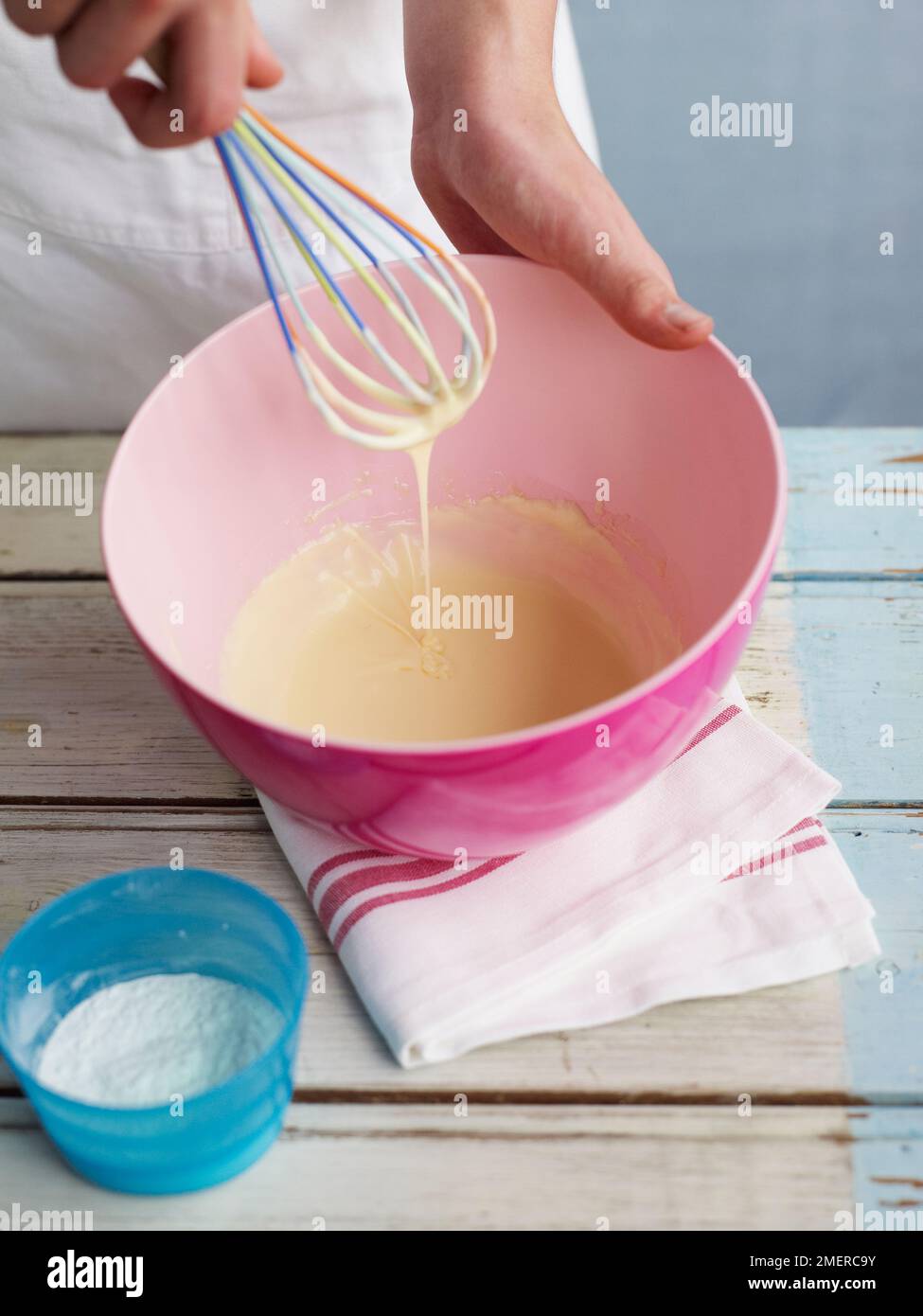Whisking cream and icing sugar mixture, making frozen yoghurt Stock Photo - Alamy