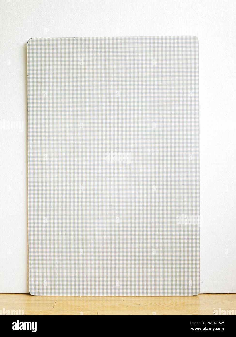 Checked pattern board against wall Stock Photo - Alamy