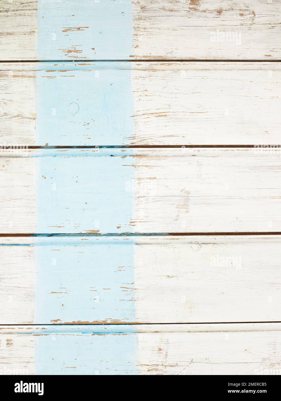 Wooden boards with blue strip painted across Stock Photo - Alamy