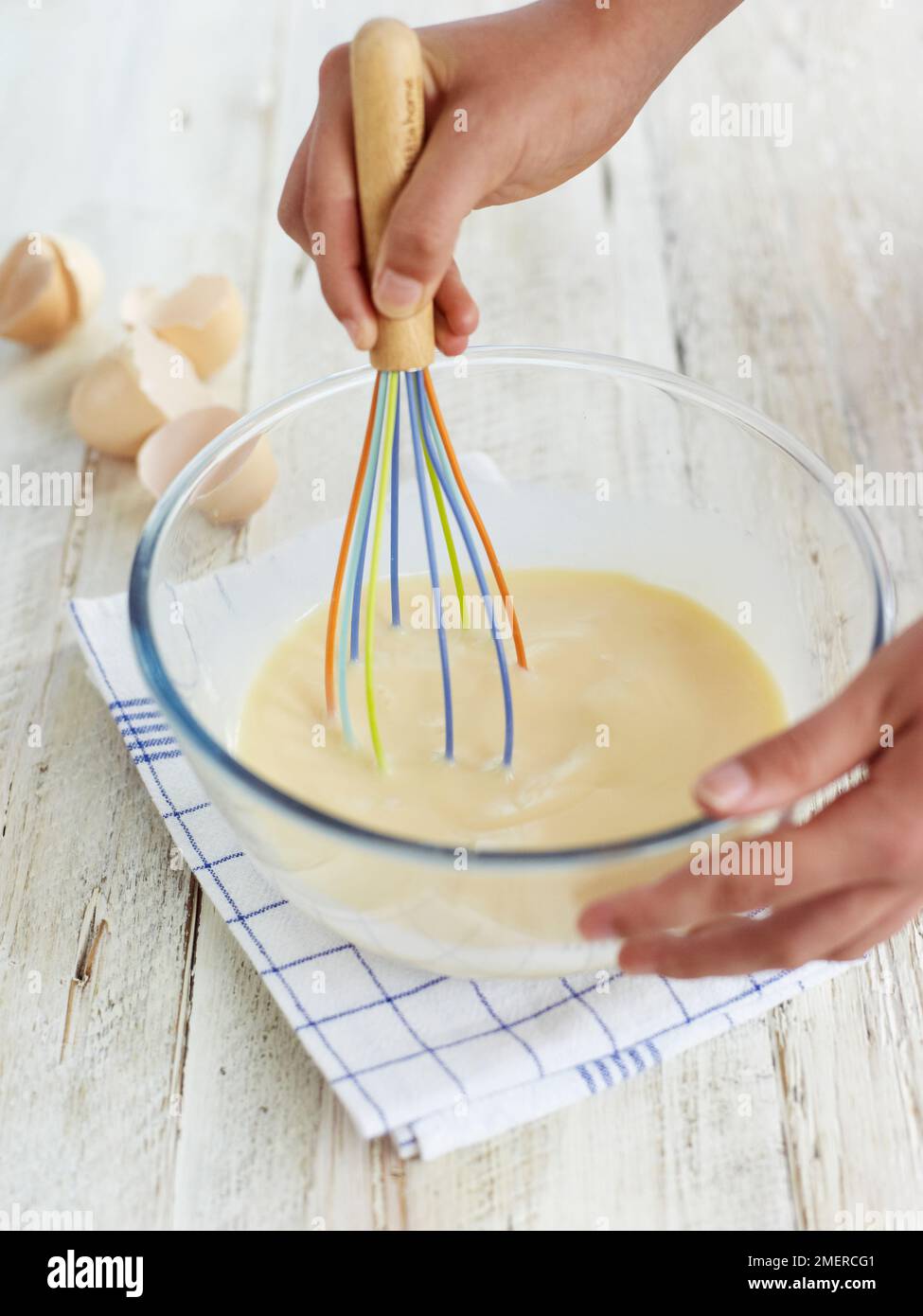 Making eggy bread, whisking together ingredients, milk, eggs and ...