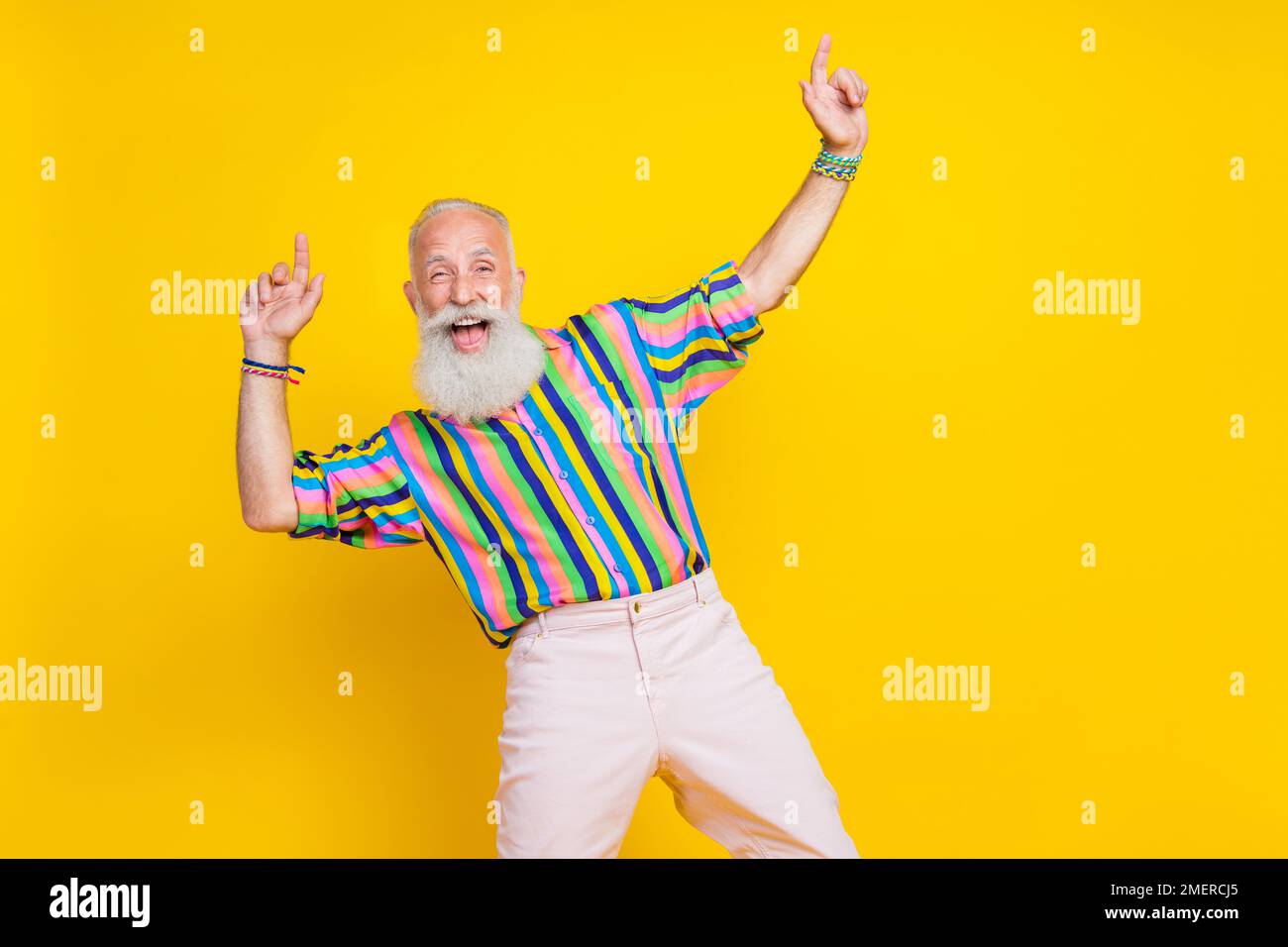 Photo of positive cool guy dressed striped shirt having fun dancing ...