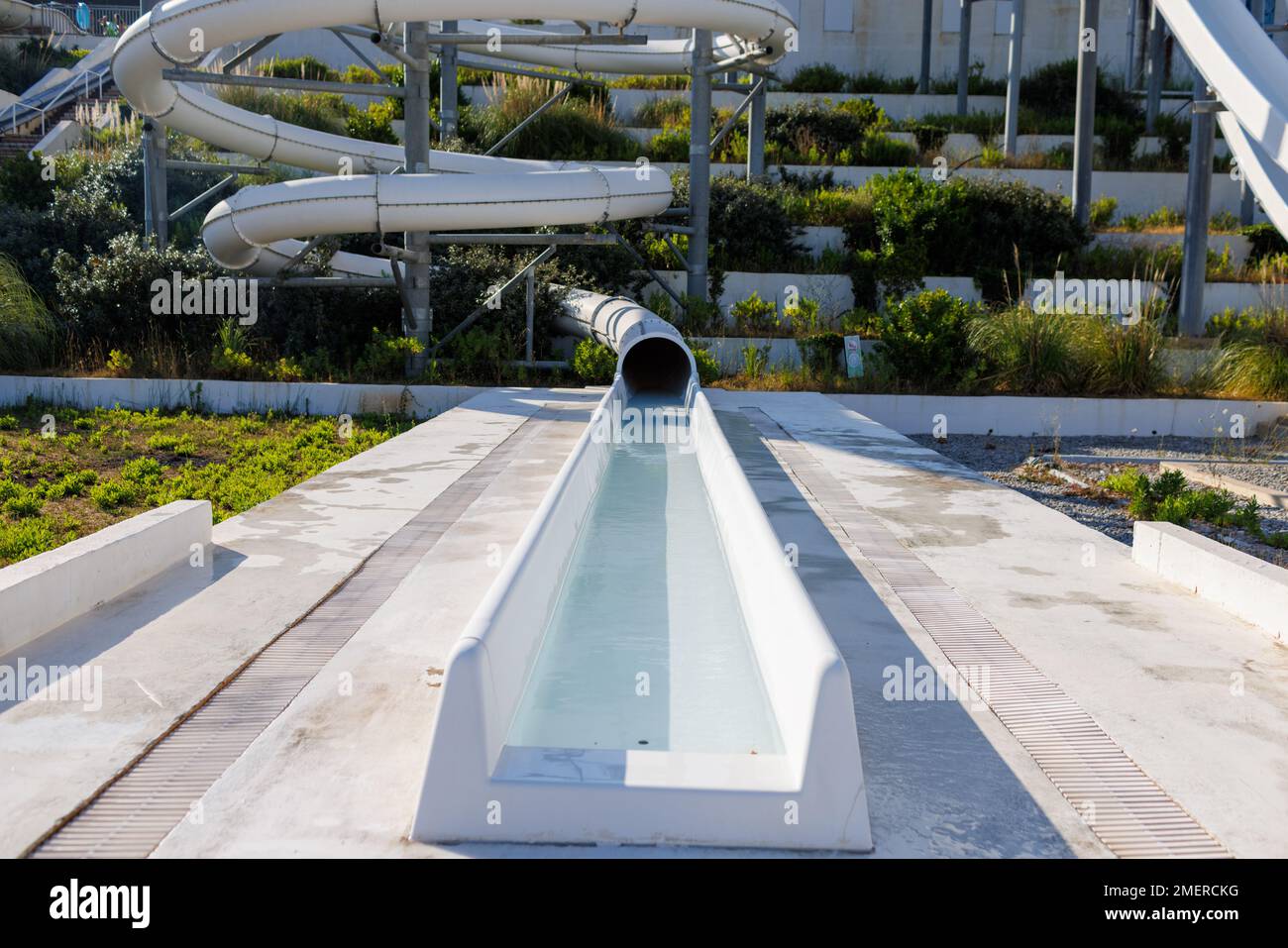 Empty indoor mountain summer water park with high extreme winding white ...