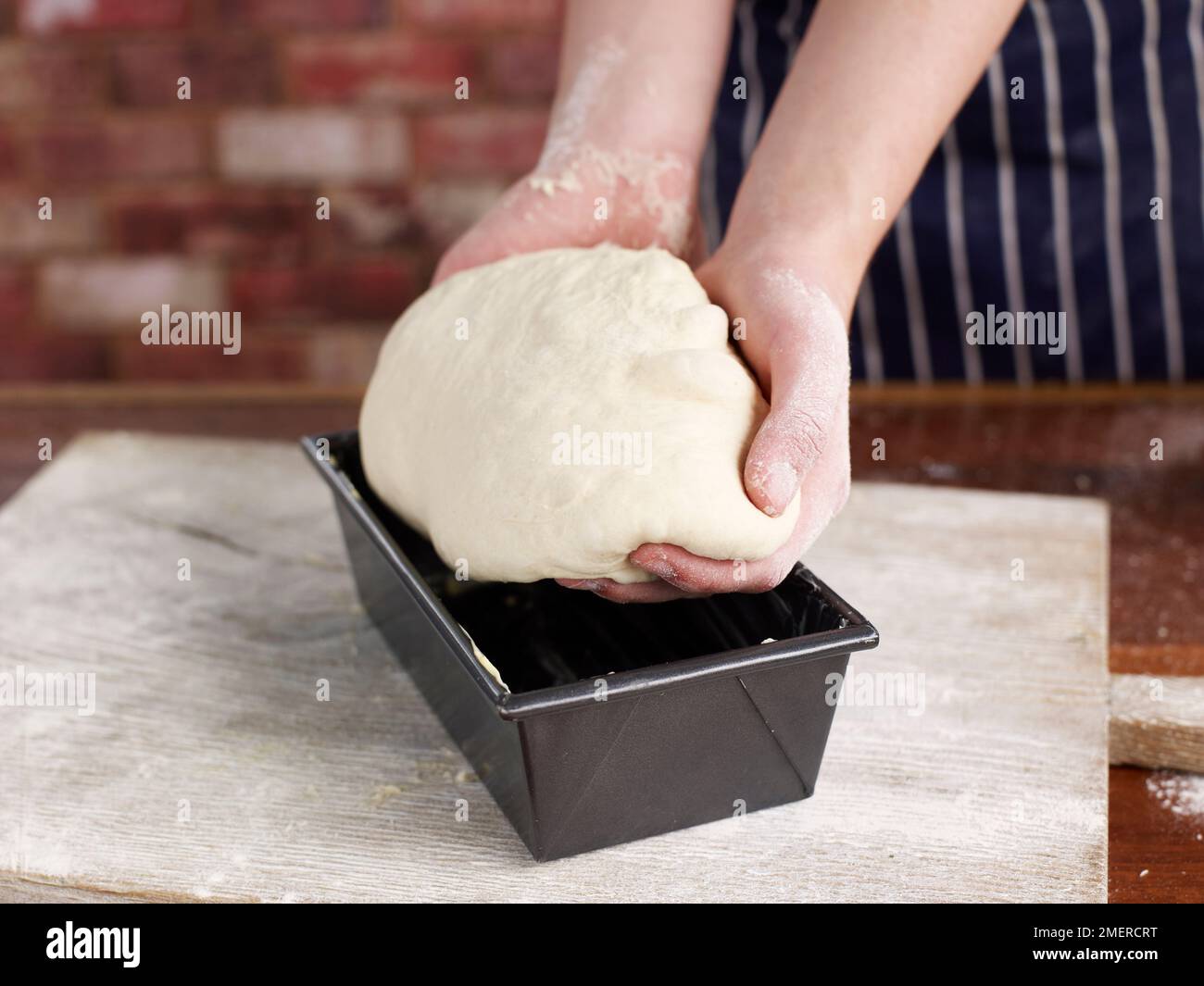 Placing bread dough into a loaf tin Stock Photo - Alamy