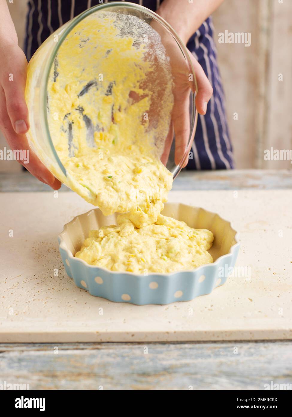 Pouring cornbread mixture into a flan tray Stock Photo - Alamy