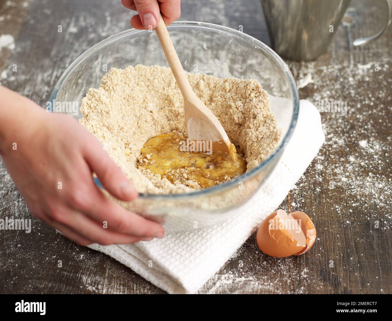 Stirring golden syrup into dough mixture, making gingerbread Stock ...