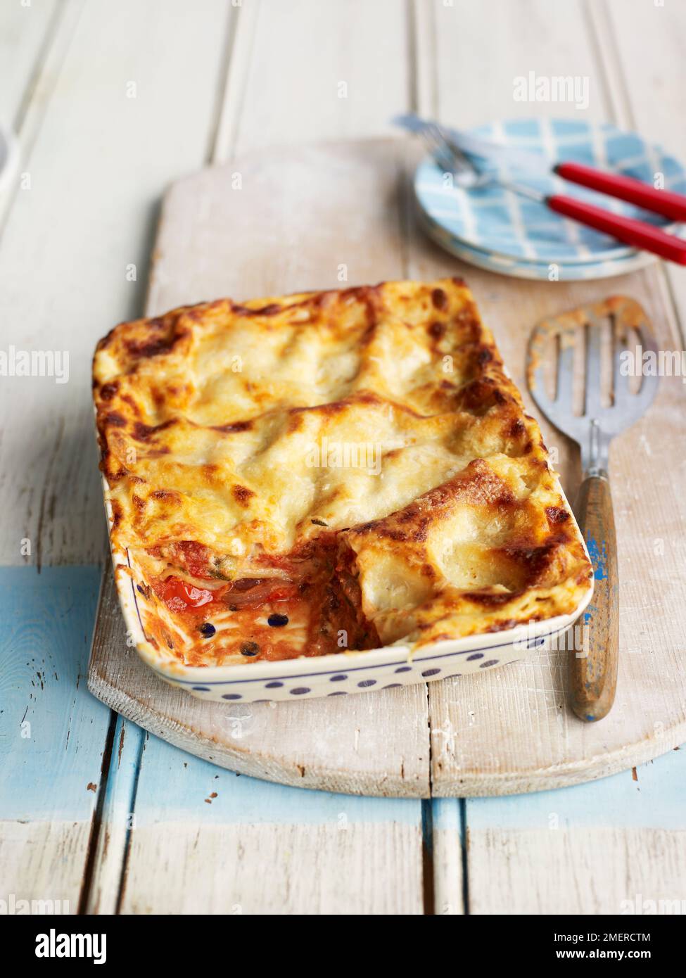 Vegetable lasagne with a slice cut out, spatula to side Stock Photo - Alamy