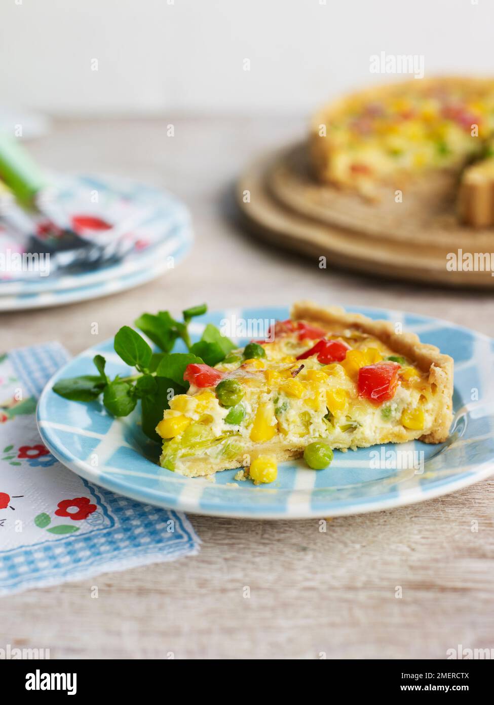 Slice of vegetable tart of sweetcorn, pepper and peas Stock Photo - Alamy