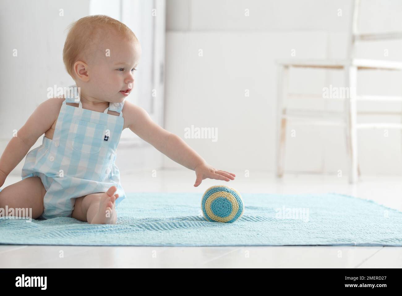 Baby reaching for toy hi-res stock photography and images - Alamy