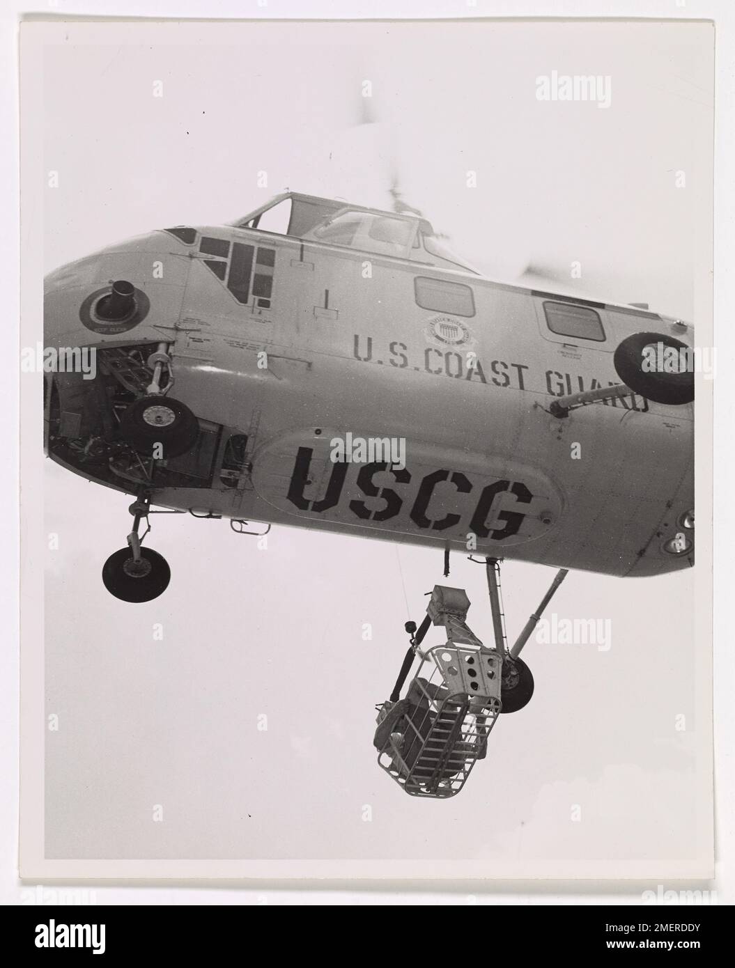 A U.S. Coast Guard helicopter is seen carrying a person in a rescue ...