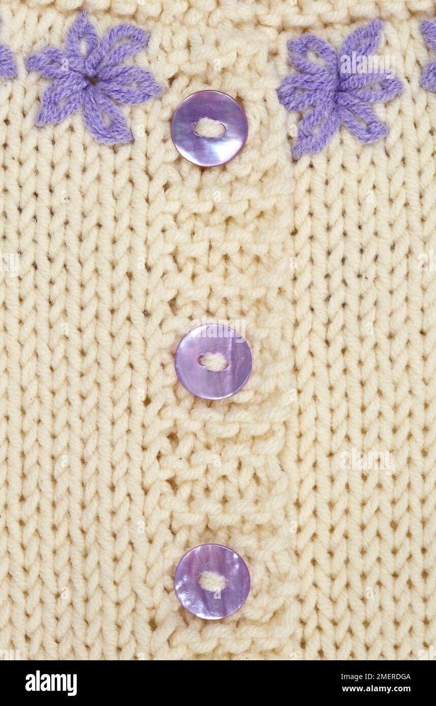 Button and daisy pattern of knitted dress Stock Photo - Alamy
