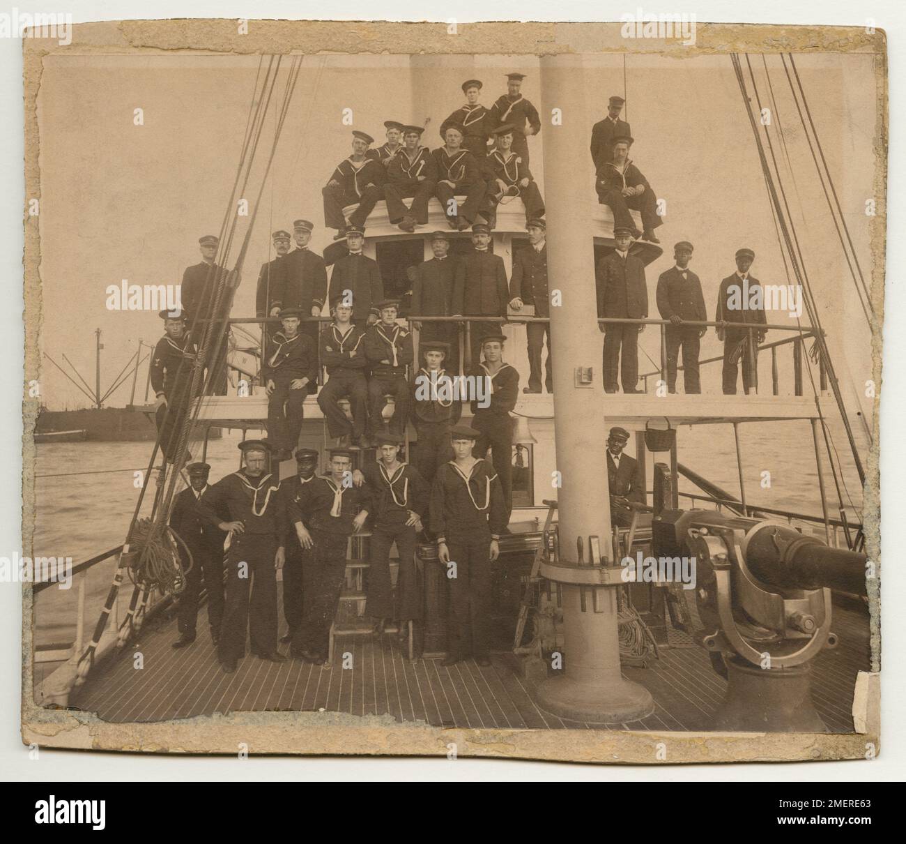 This group portrait shows Coast Guardsmen aboard a Coast Guard vessel ...
