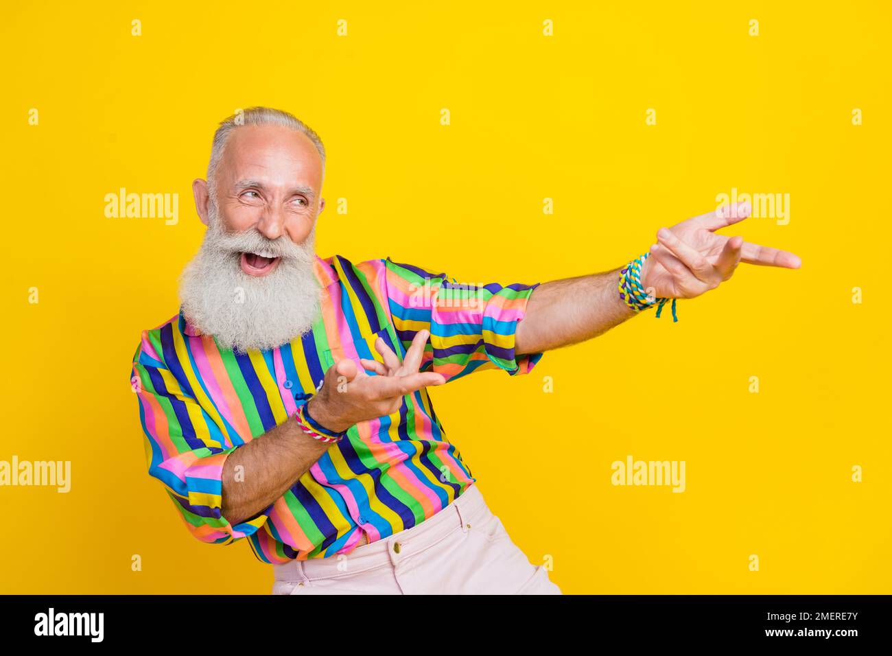 Photo of cool excited guy dressed striped shirt having fun looking ...