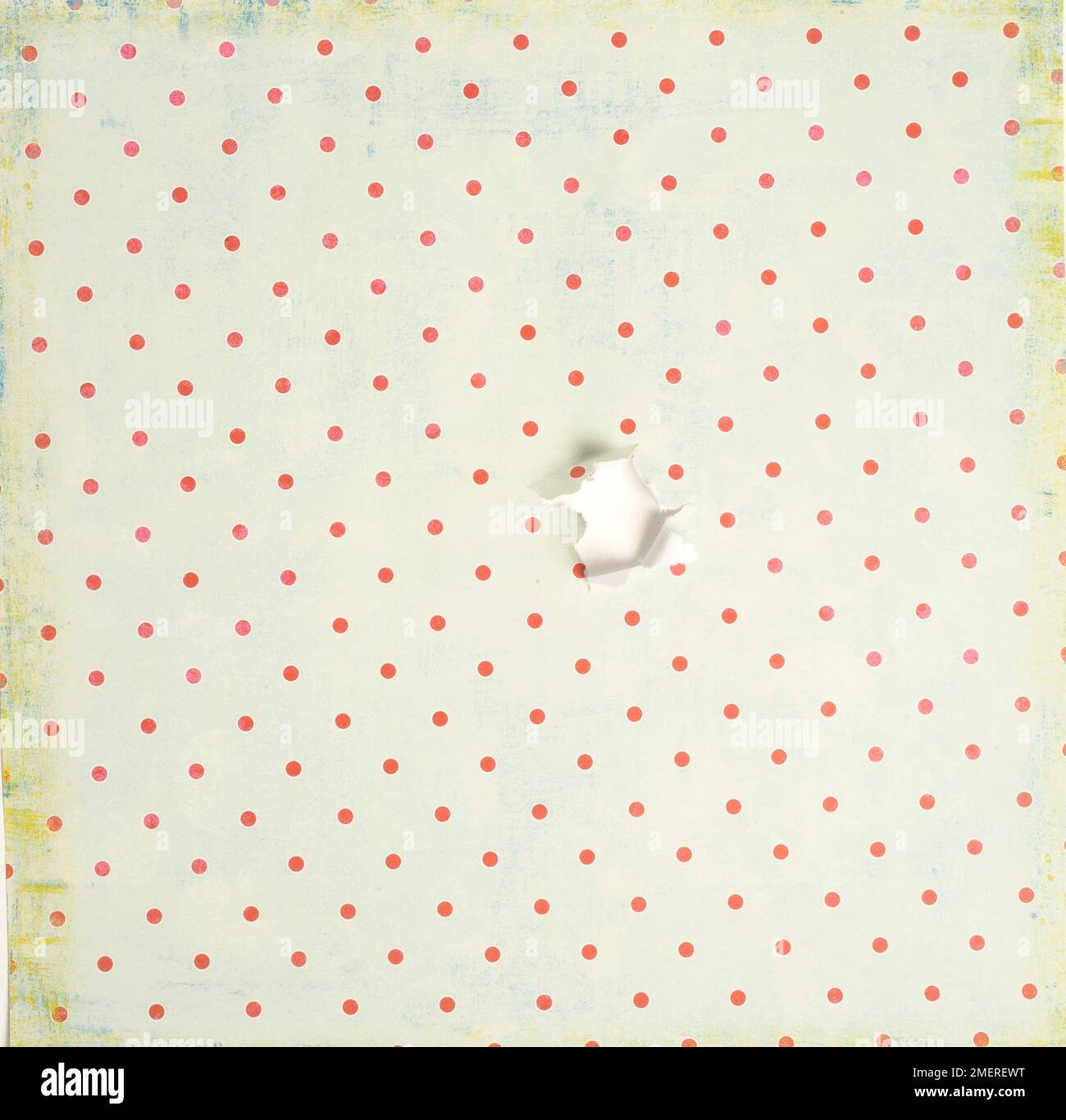 Hole in polka dot wrapping paper Stock Photo - Alamy