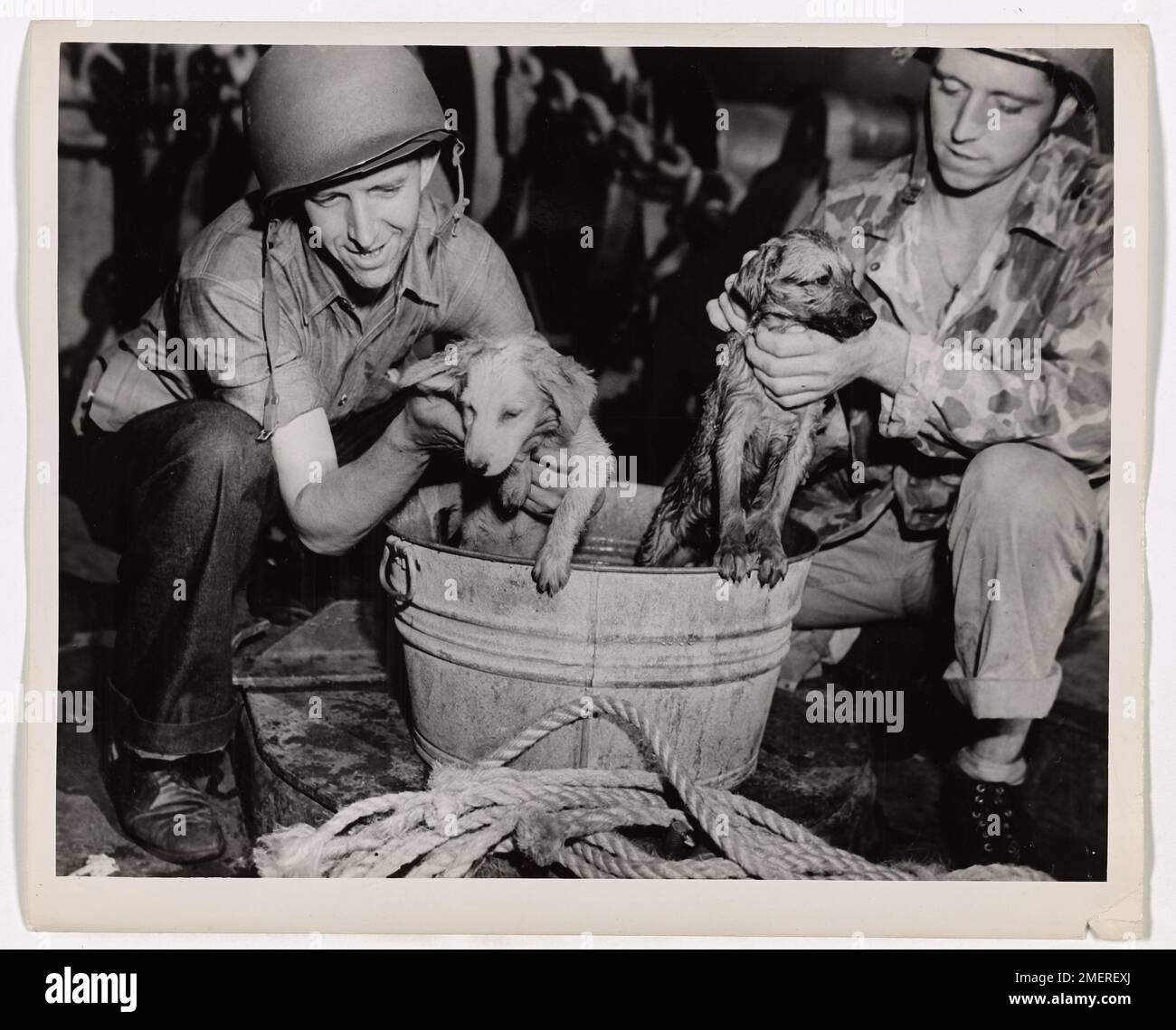 Two Marine Corps 'Devil Dogs' are seen having fun in a bucket aboard a ...