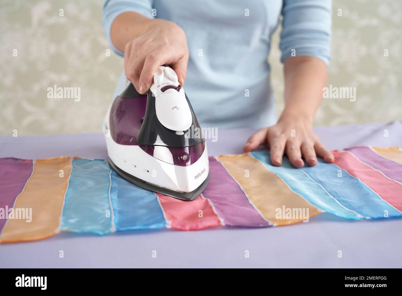 Ironing painted silk scarf Stock Photo - Alamy