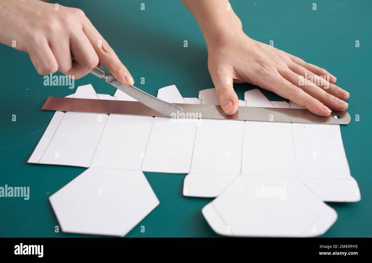 Scoring lines on cut out flat gift box Stock Photo - Alamy