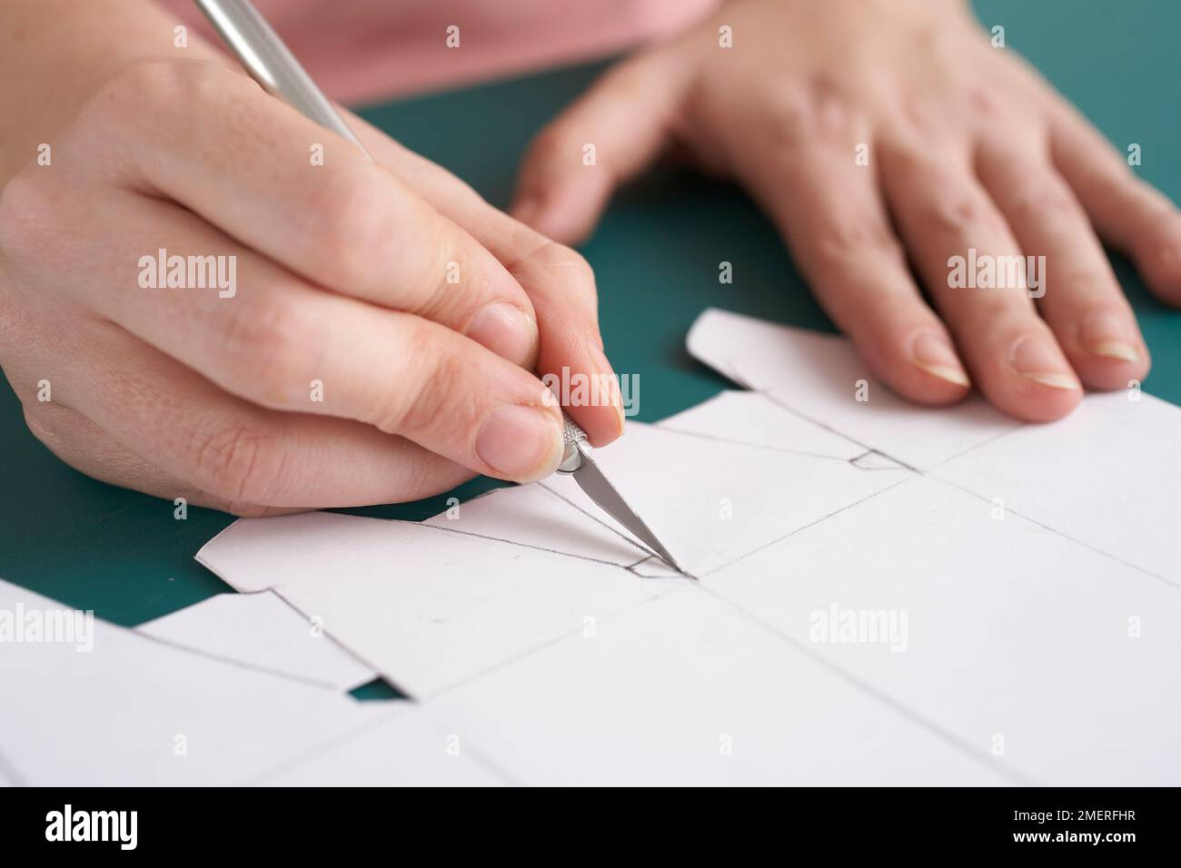 Cutting out shapes on pattern for gift box Stock Photo - Alamy