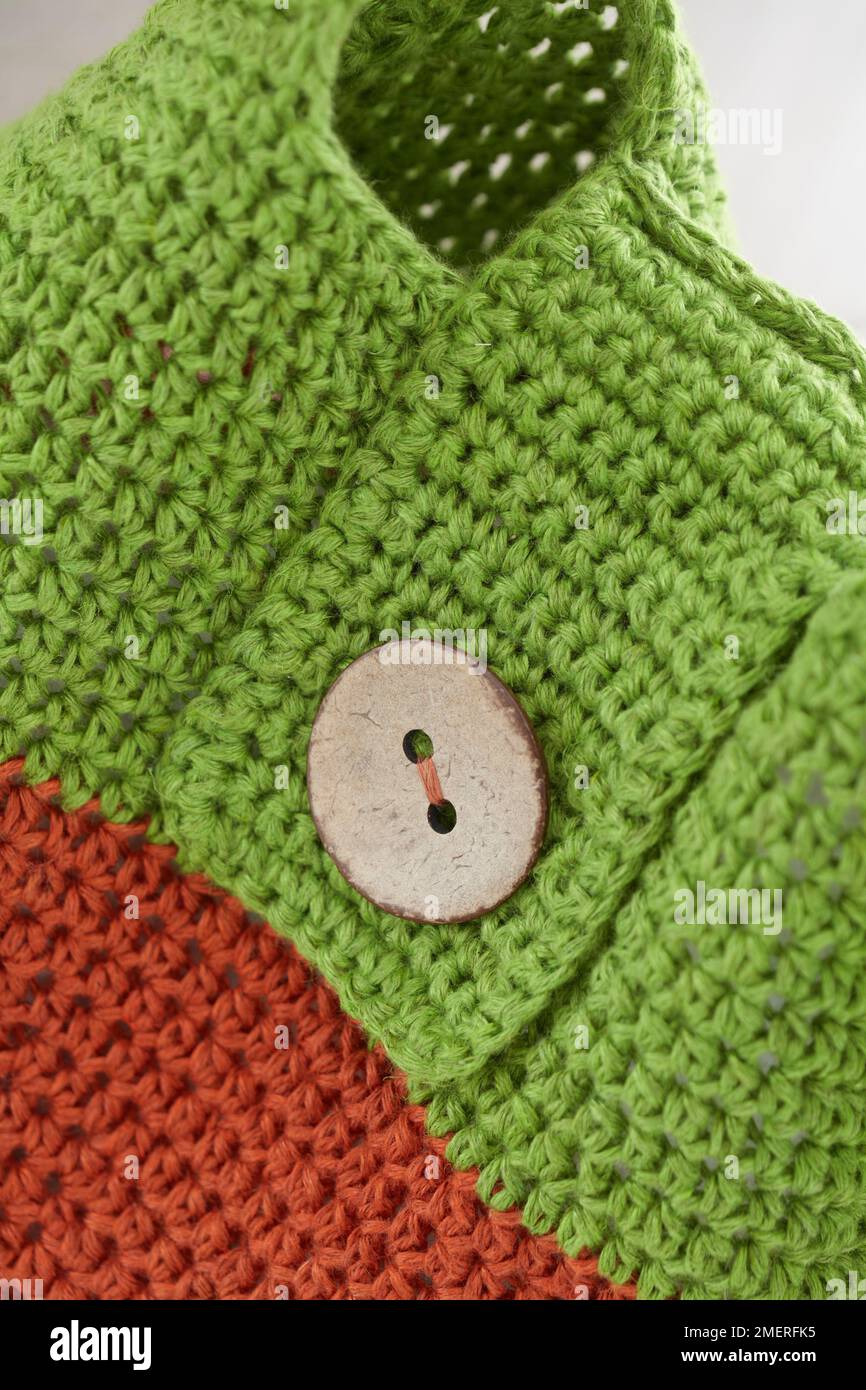 Crocheted beach bag, button fastening Stock Photo - Alamy