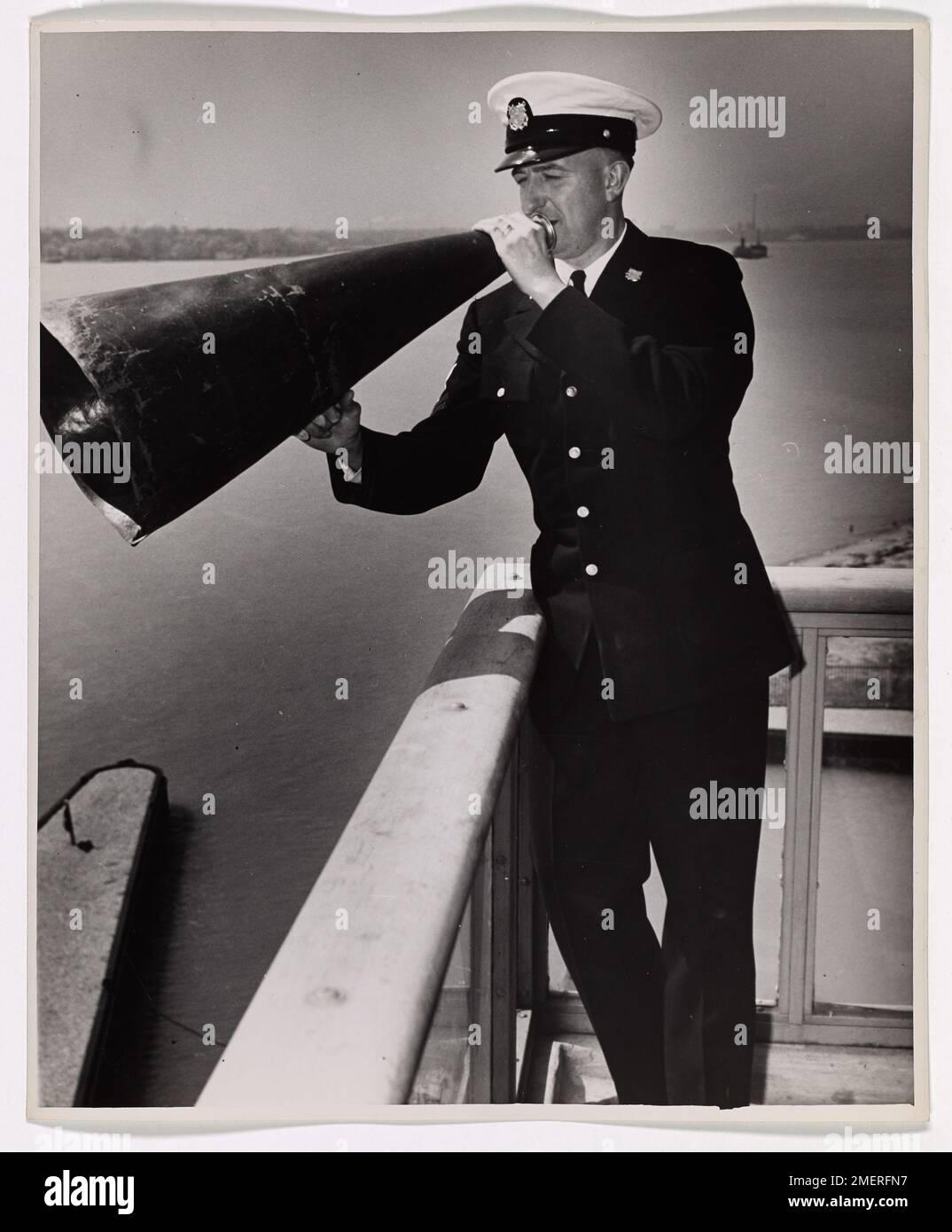 Boatswain's Mate Second Class Charles W. Hiner uses a megaphone from ...