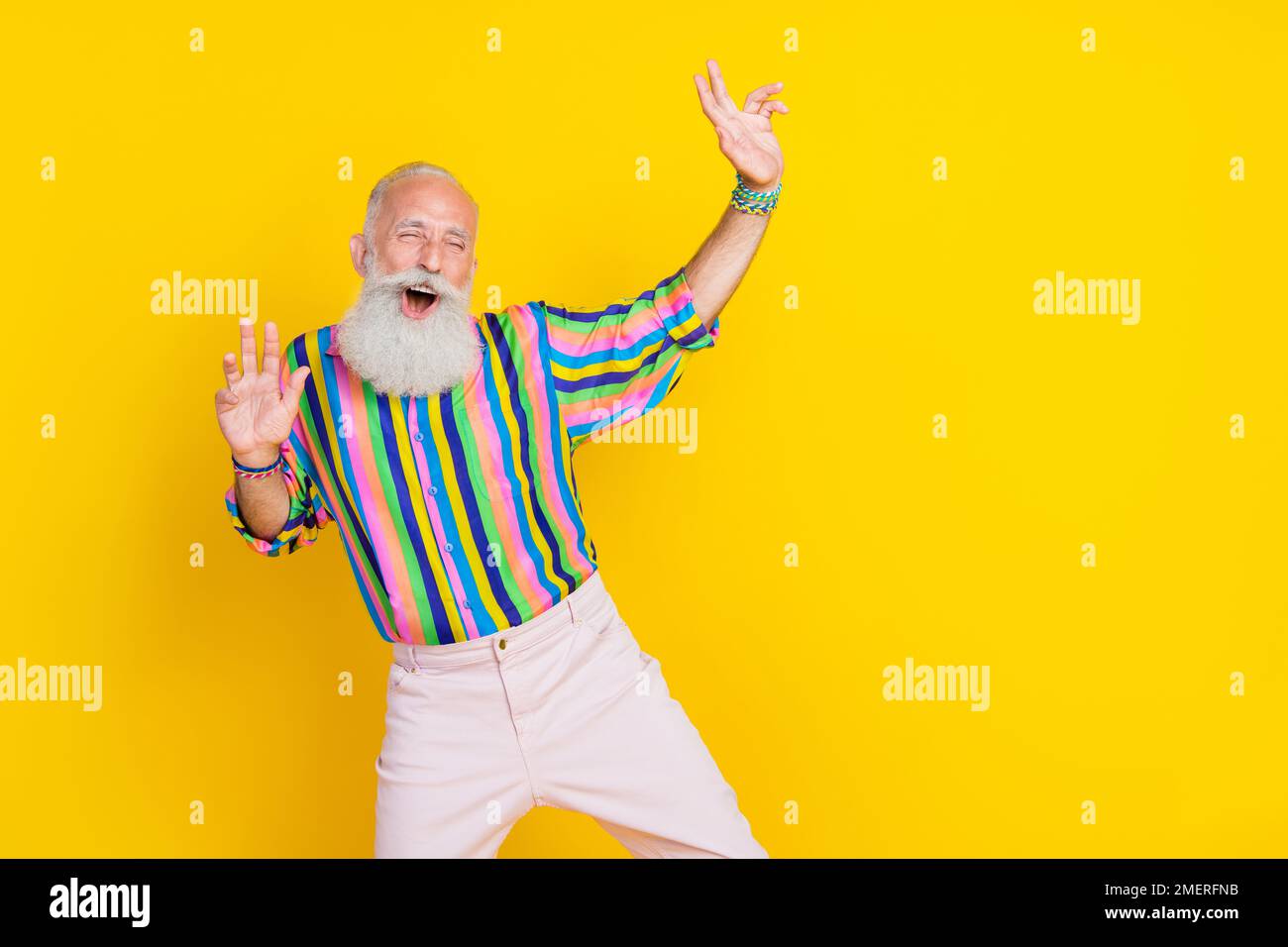Photo of excited cheerful guy dressed striped shirt having fun enjoying ...
