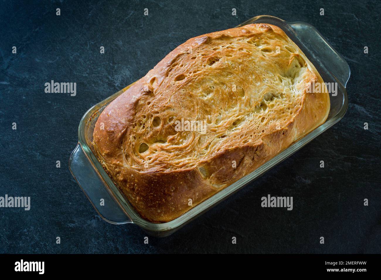 A loaf of homemade white bread in a glass loaf pan Stock Photo - Alamy