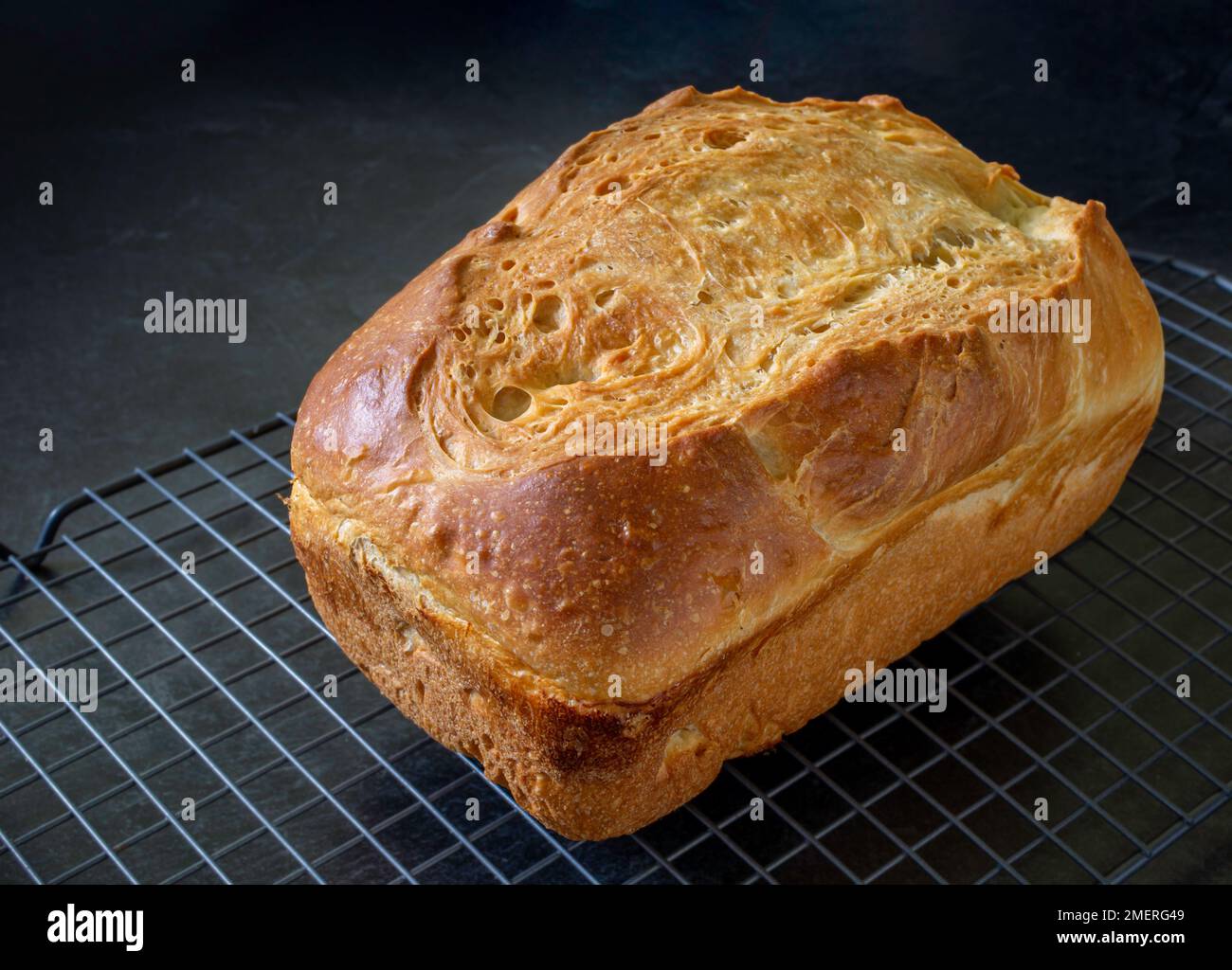A loaf of homemade white bread on a wire cooling rack Stock Photo - Alamy