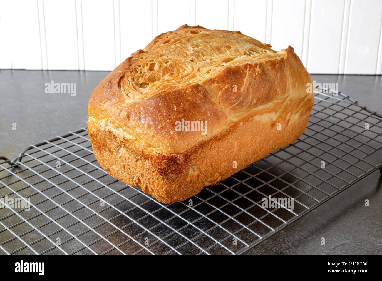 A loaf of homemade white bread on a wire cooling rack Stock Photo - Alamy
