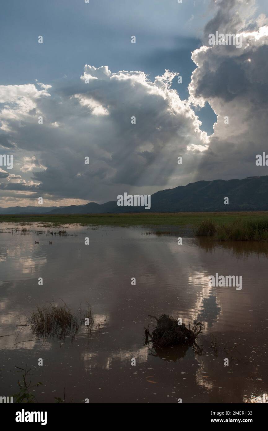 Myanmar, Eastern Burma, Inle Lake, sunlight breaking through clouds ...