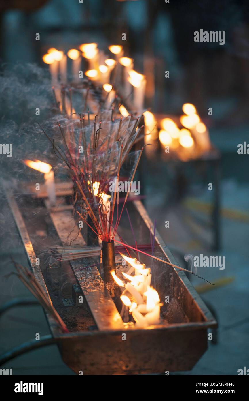 Myanmar, Yangon, Shwedagon Paya, lighting candles and incense sticks in ...