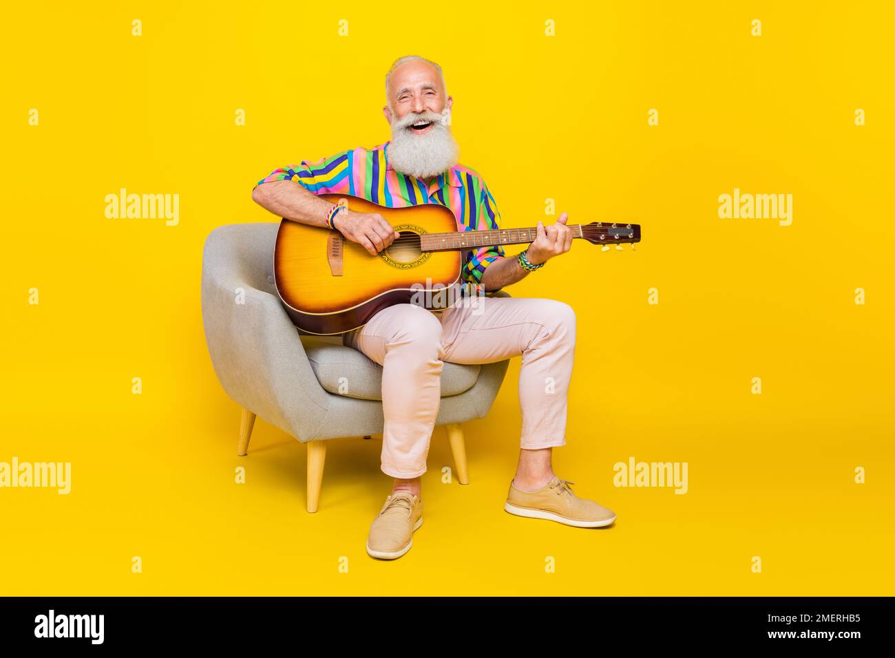 Portrait Of Optimistic Old Man With Long Beard Wear Colorful Shirt Sit