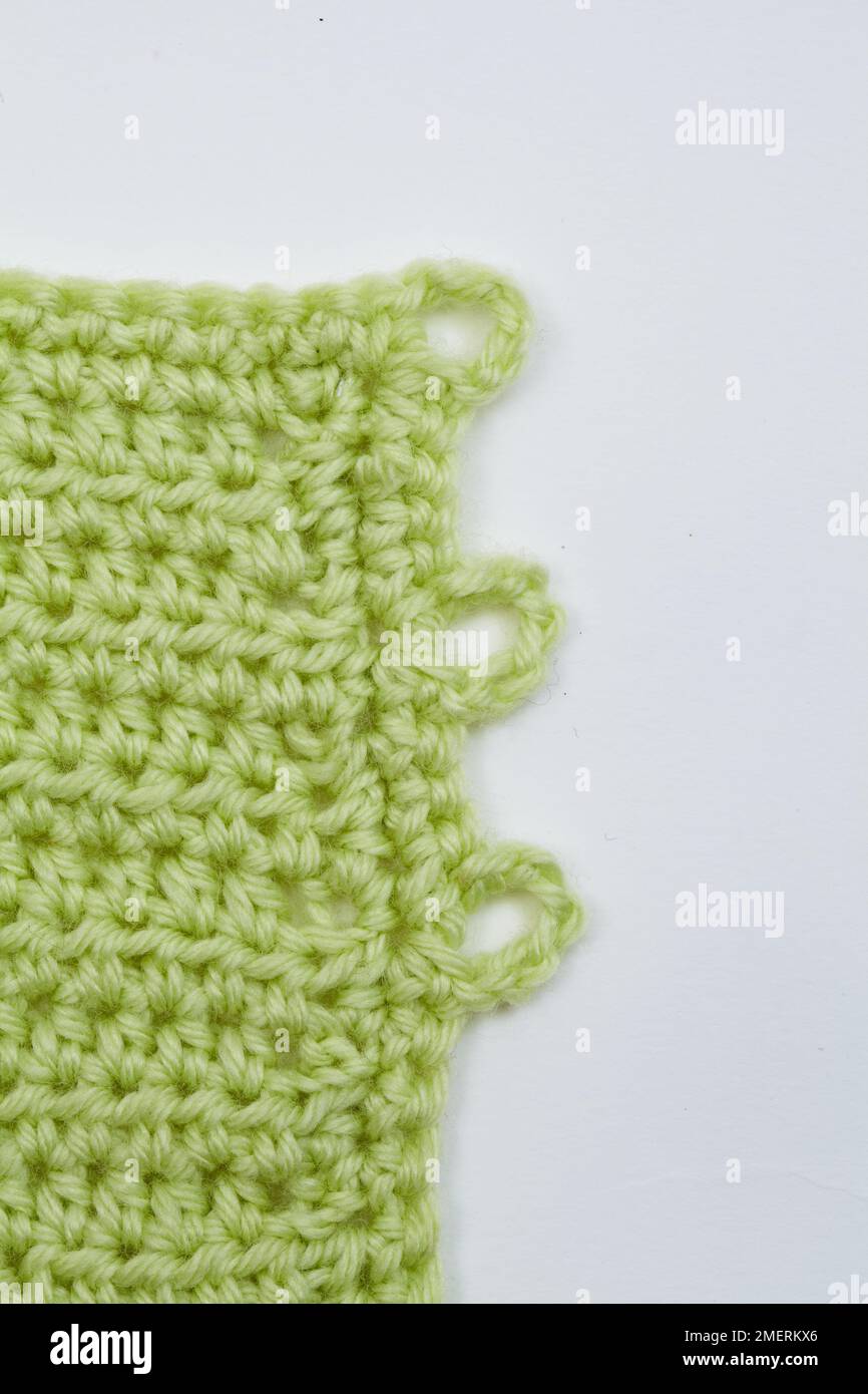 Button loop detail on crocheted baby's cardigan Stock Photo - Alamy
