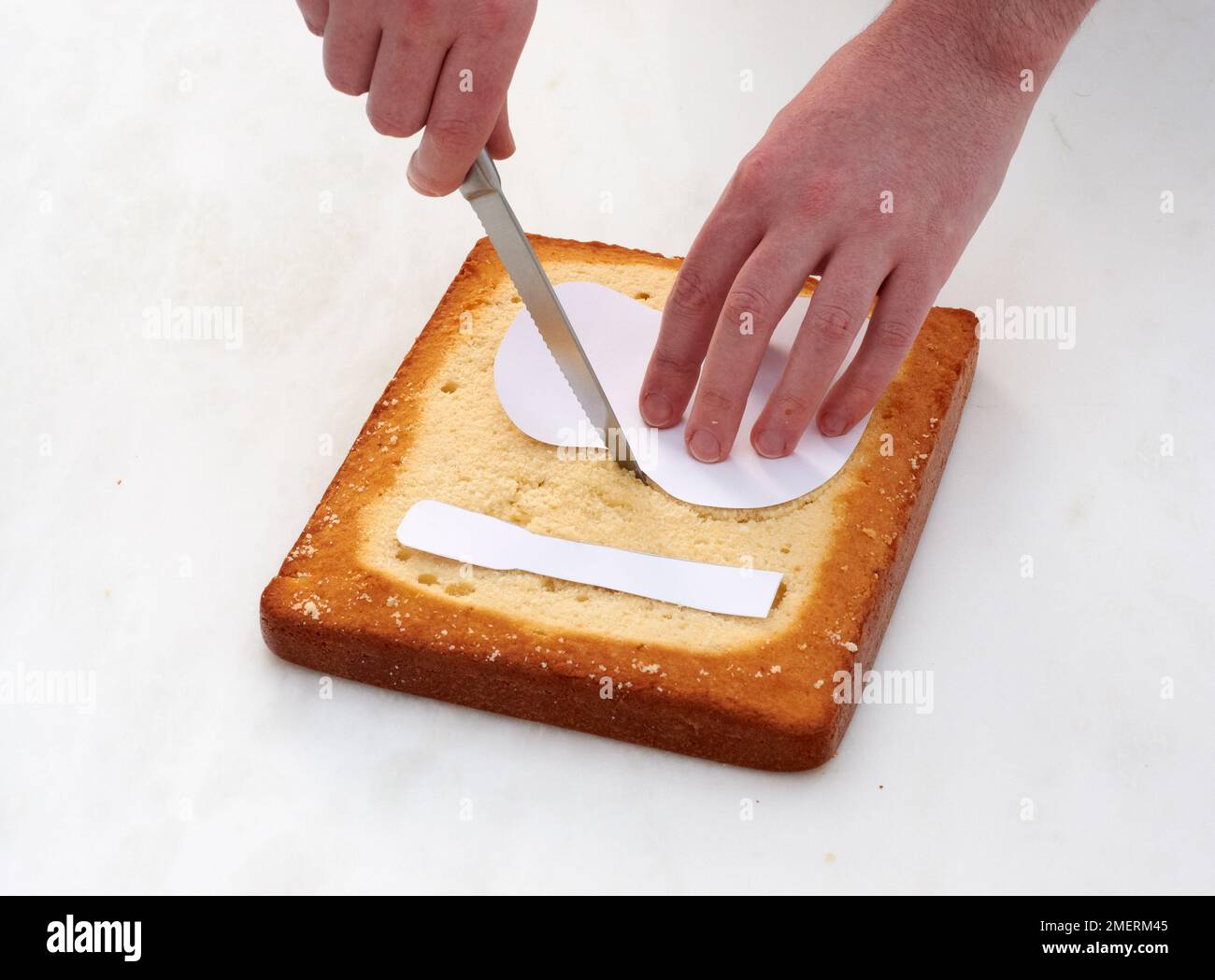 Carving shapes from sponge cake Stock Photo - Alamy
