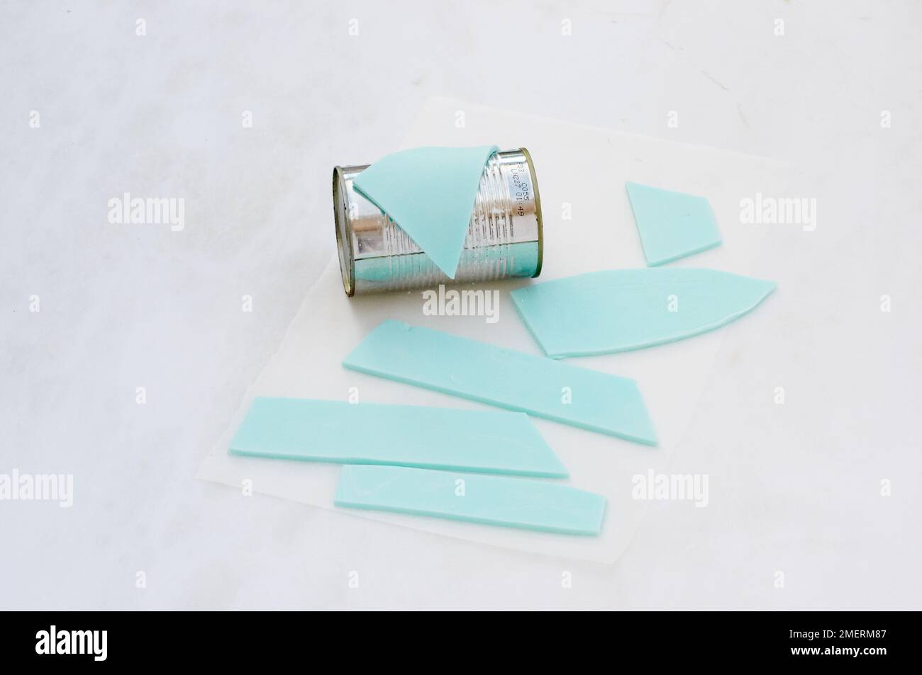 Modelling fondant icing shapes using a metal tin Stock Photo - Alamy