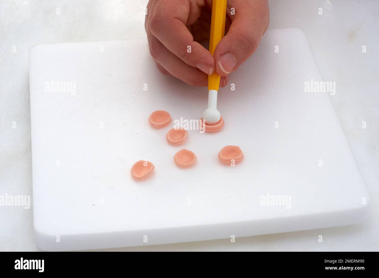 Shaping fondant icing using tool Stock Photo - Alamy